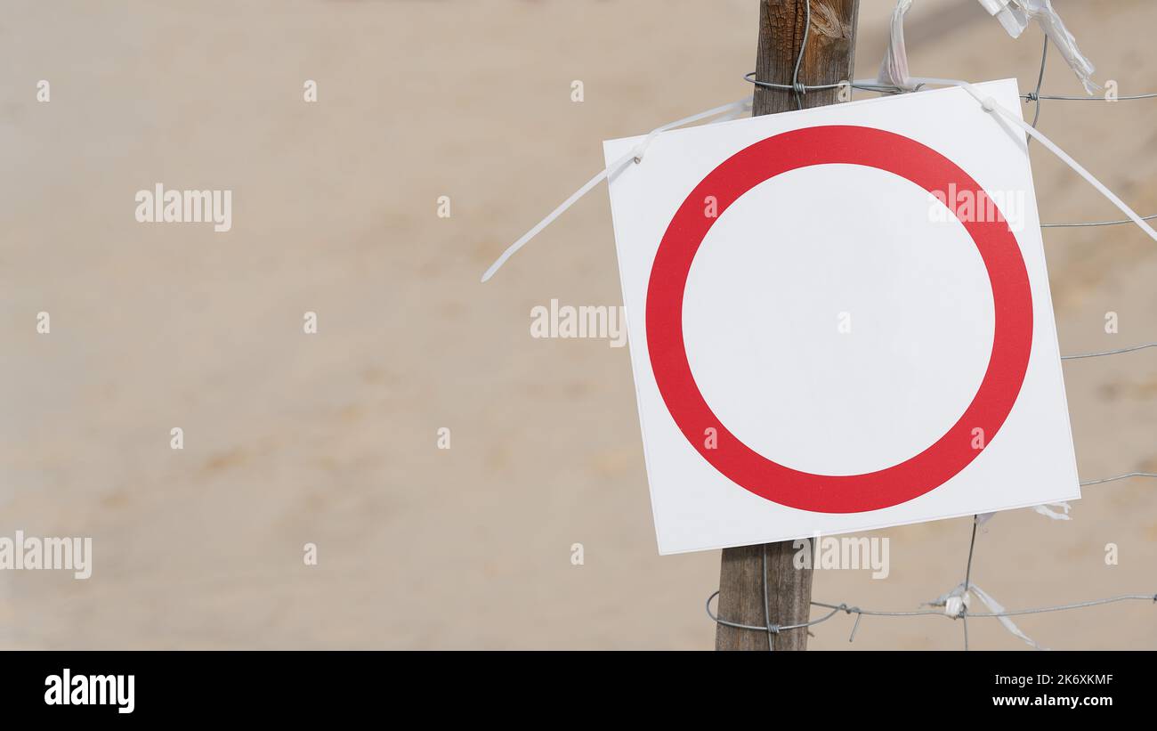 Empty sign on the beach with copy space on the left and on the sign ...