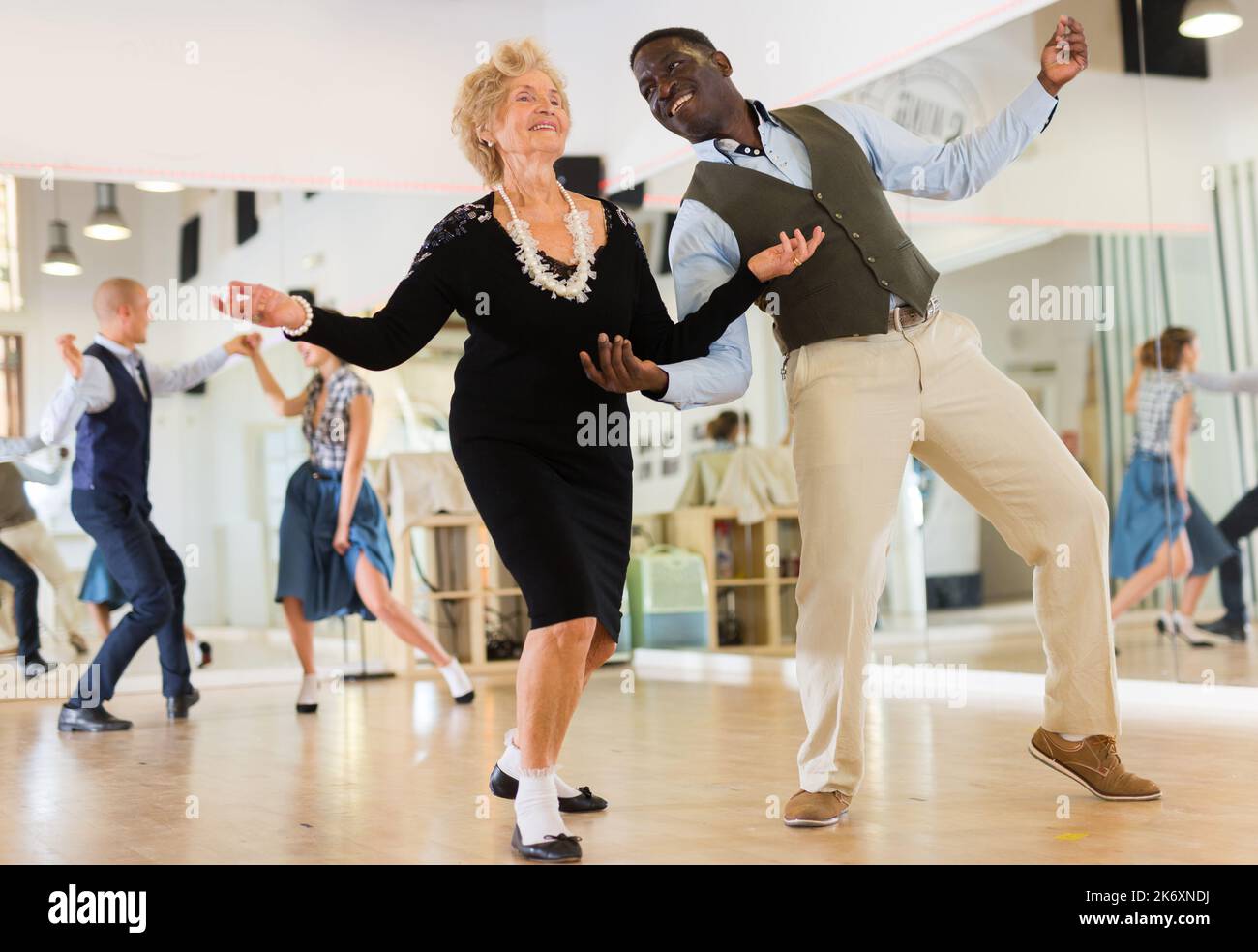 Lady learning to dance lindy hop with man in dance school Stock Photo ...