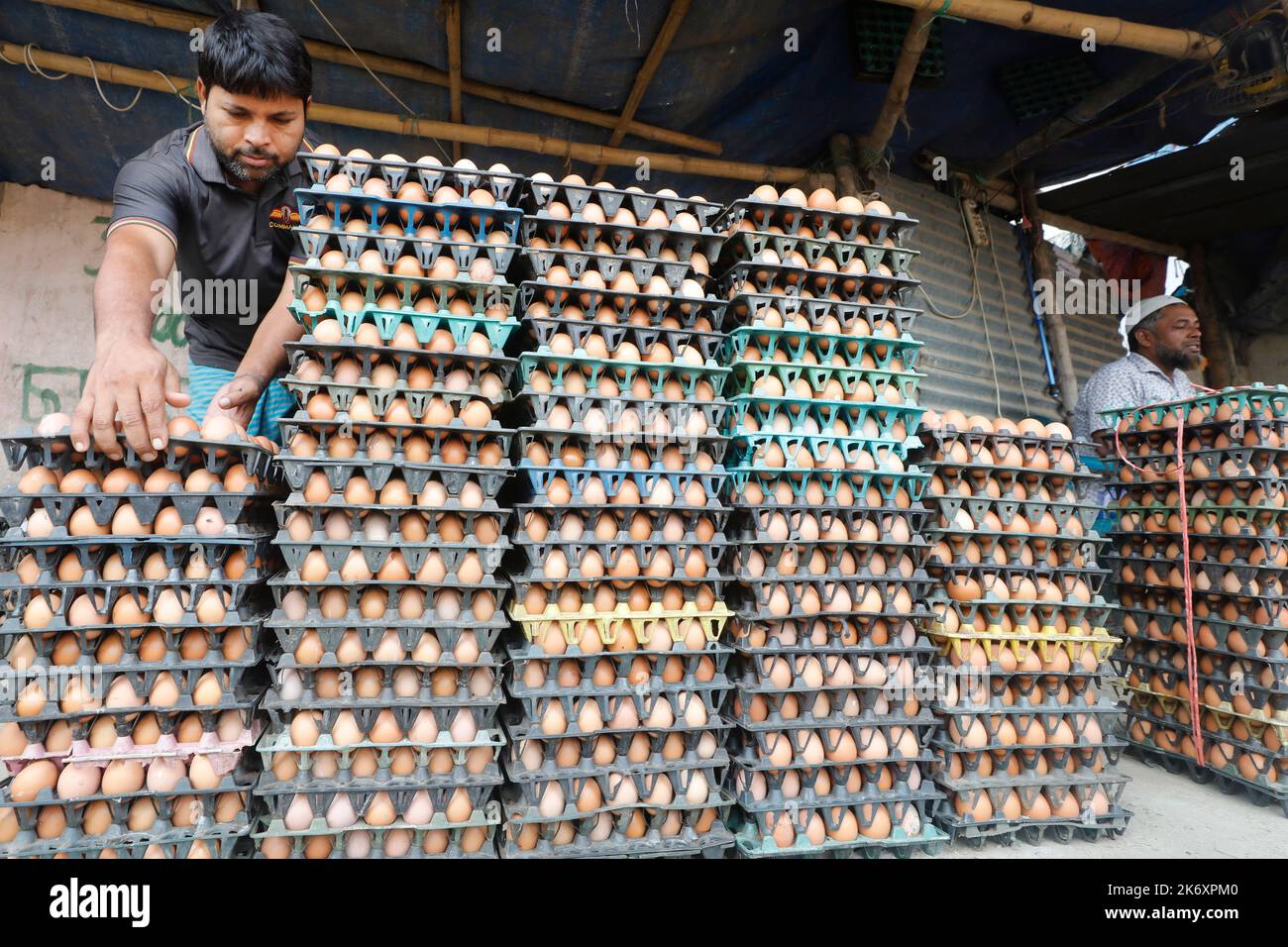 Dhaka, Bangladesh - September 08, 2022: Bangladeshi traders wait for customers by arranging eggs ...