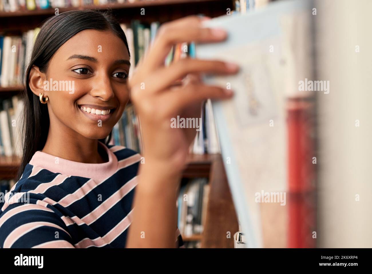This looks like the perfect book. a young female student doing research ...