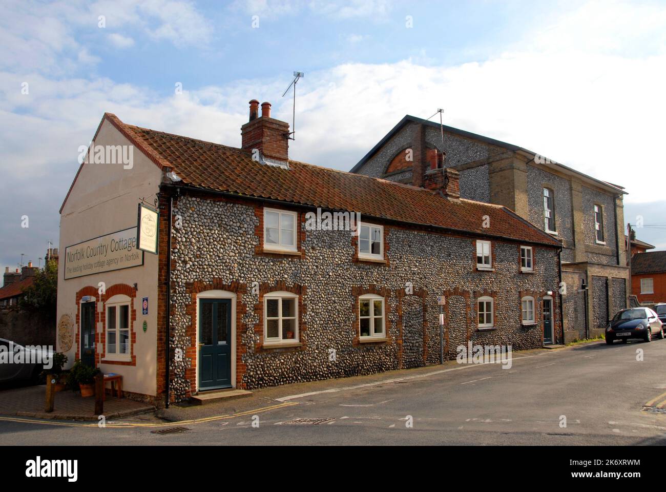 Attractive building with cobblestone facing on the walls and two doors ...