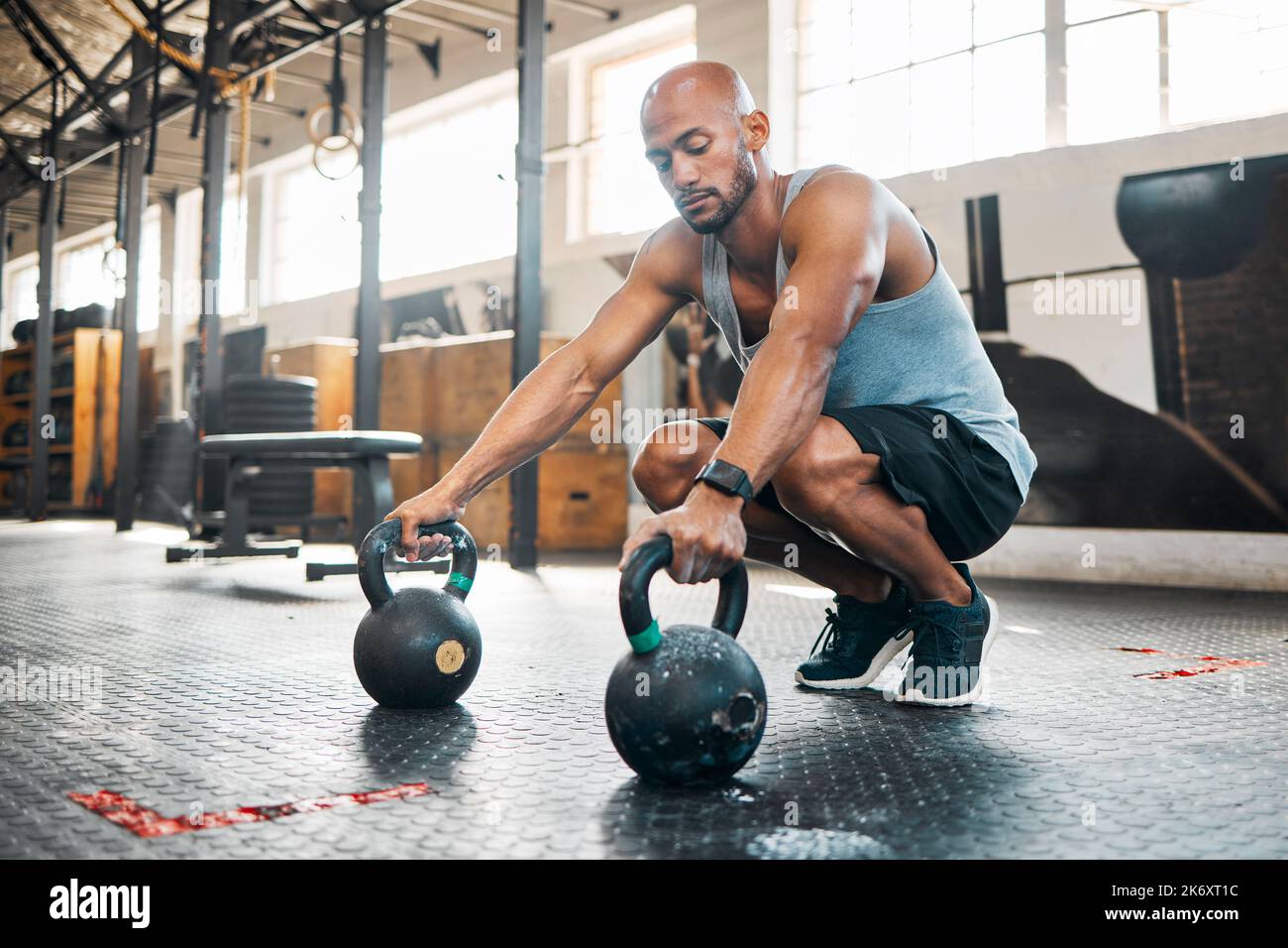 Lift your way to stronger form. a young man getting ready to use ...