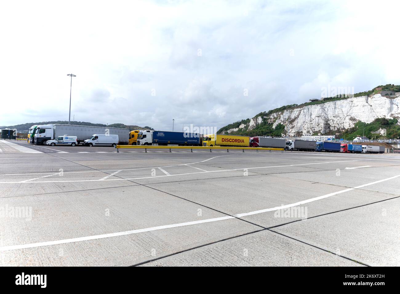 Freight lorries, and cars parked at Port of Dover, Kent, UK. The white ...