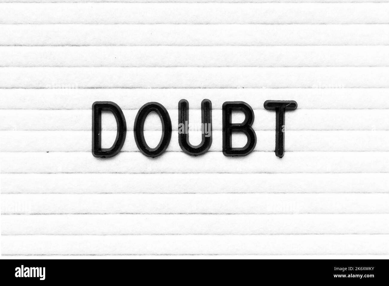 Black color letter in word doubt on white felt board background Stock ...