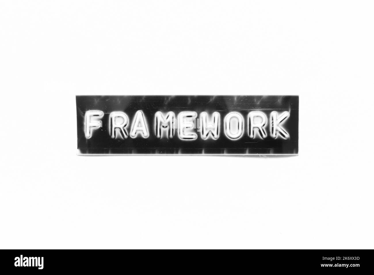 Embossed letter with word framework in black banner on white paper ...