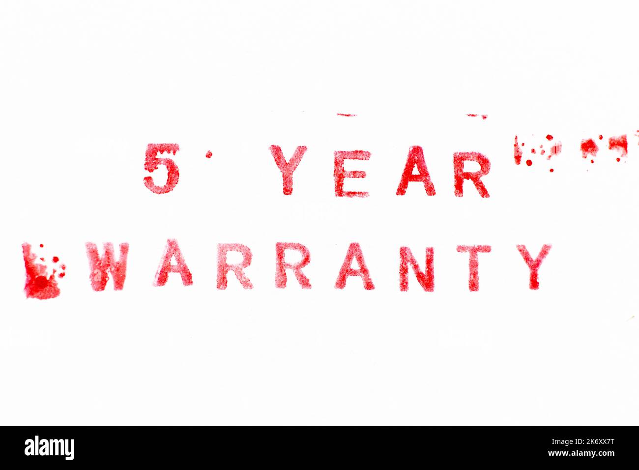 Red color ink rubber stamp in word 5 year warranty on white paper ...
