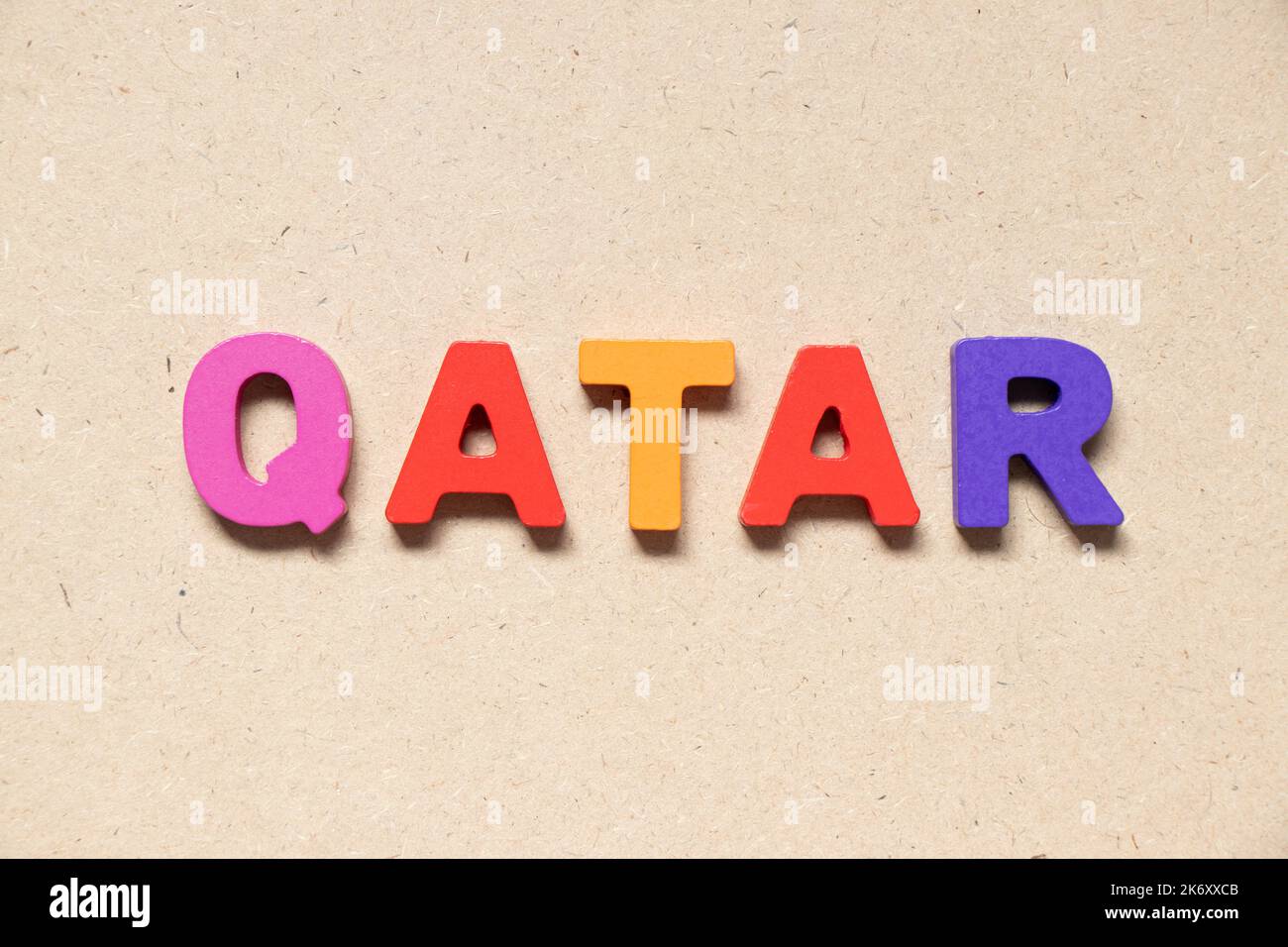 Color alphabet letter in word qatar on wood background Stock Photo - Alamy