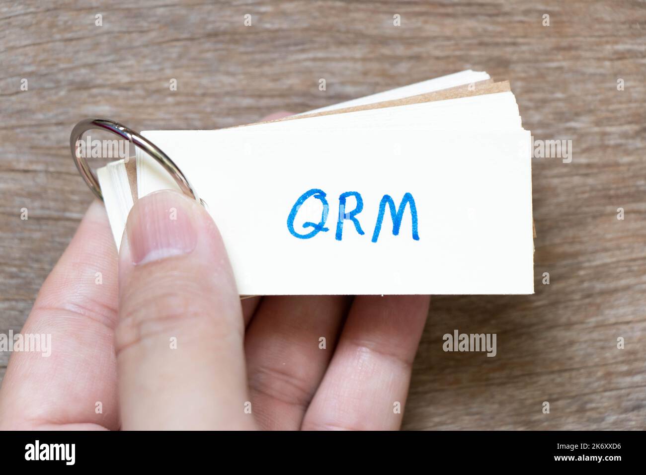 Hand hold flash card with handwriting in word QRM (Abbreviation of ...