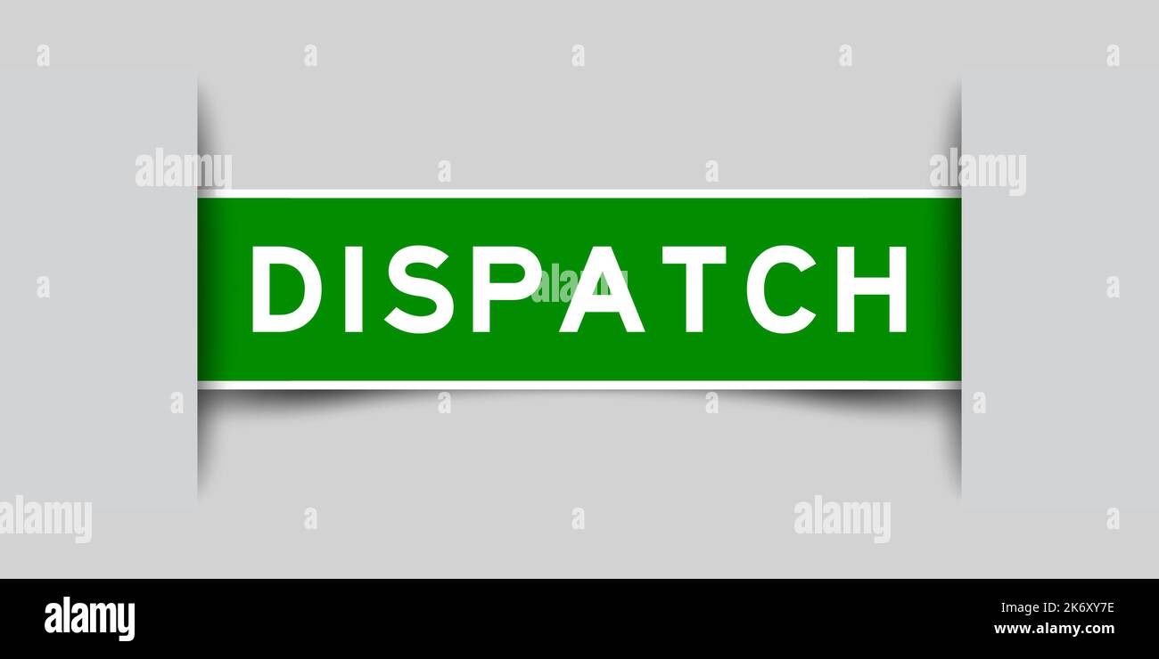 Inserted green color label sticker with word dispatched on gray ...