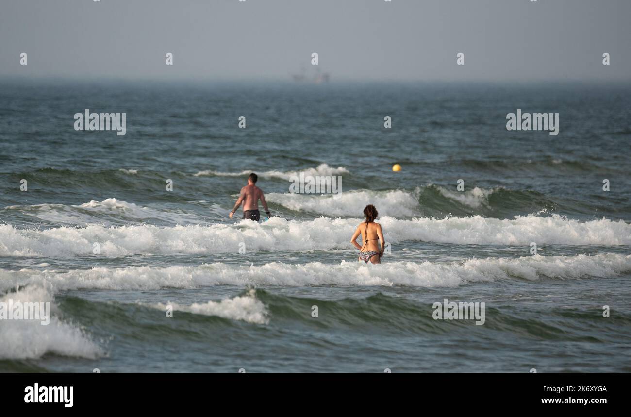 Rough sea. People on the waves at sea. Swimming in the sea with big ...