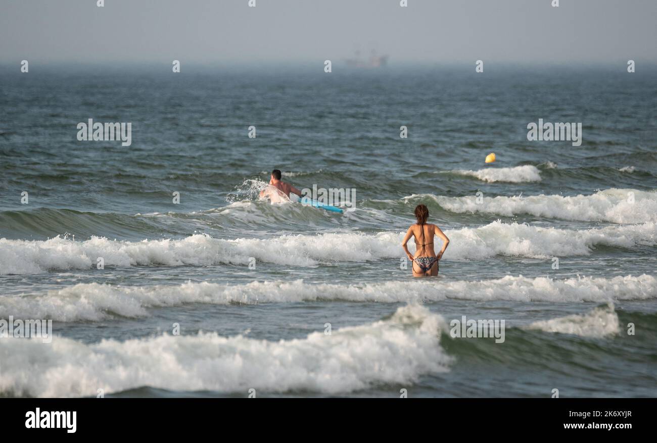 Rough sea. People on the waves at sea. Swimming in the sea with big ...