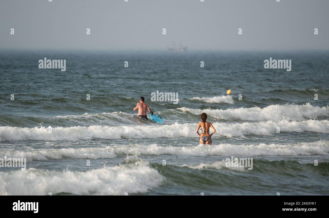 Rough sea. People on the waves at sea. Swimming in the sea with big ...