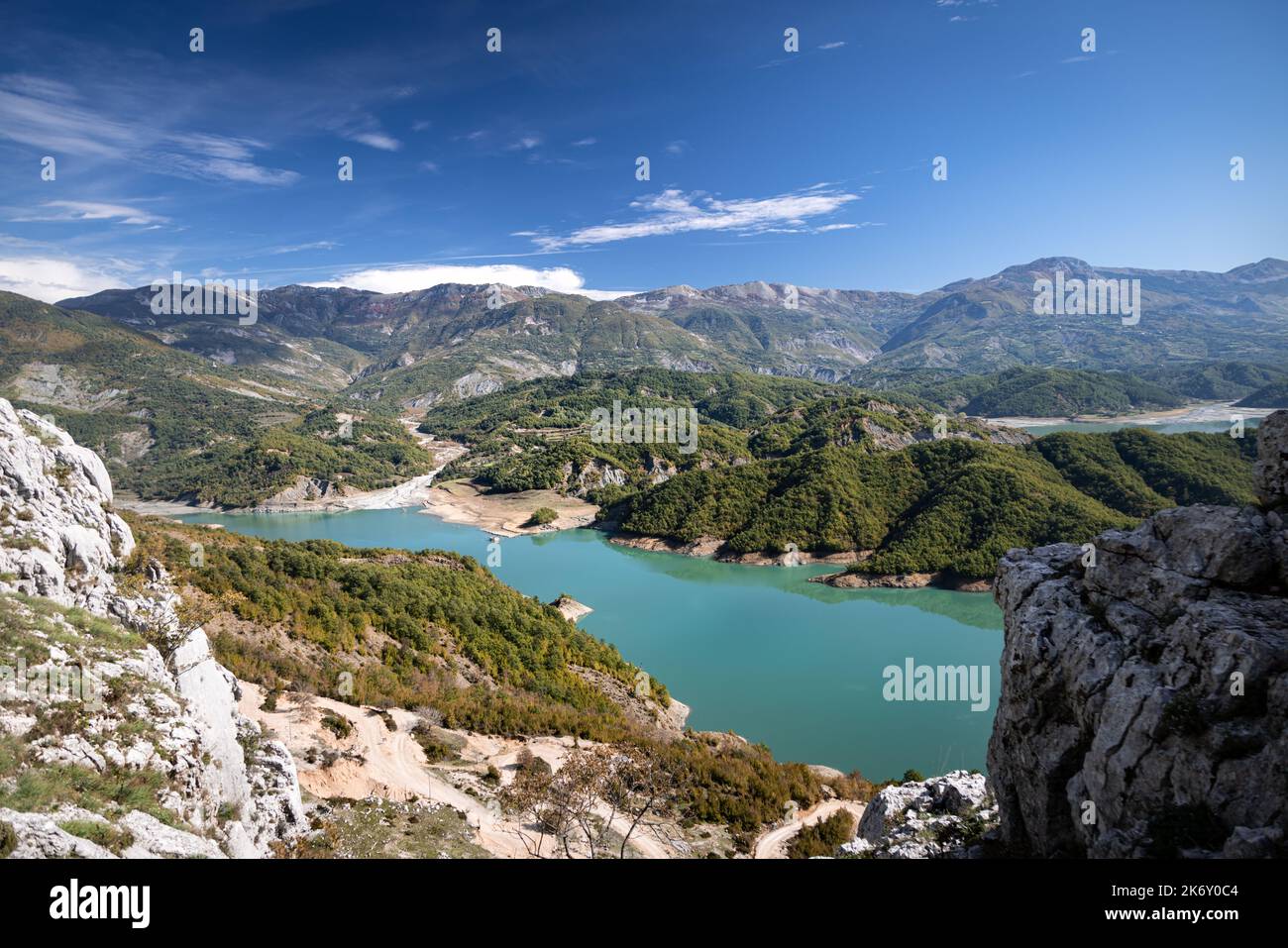 The water reservoir Lake Bovilla surrounded by mountains, blue sky, in ...