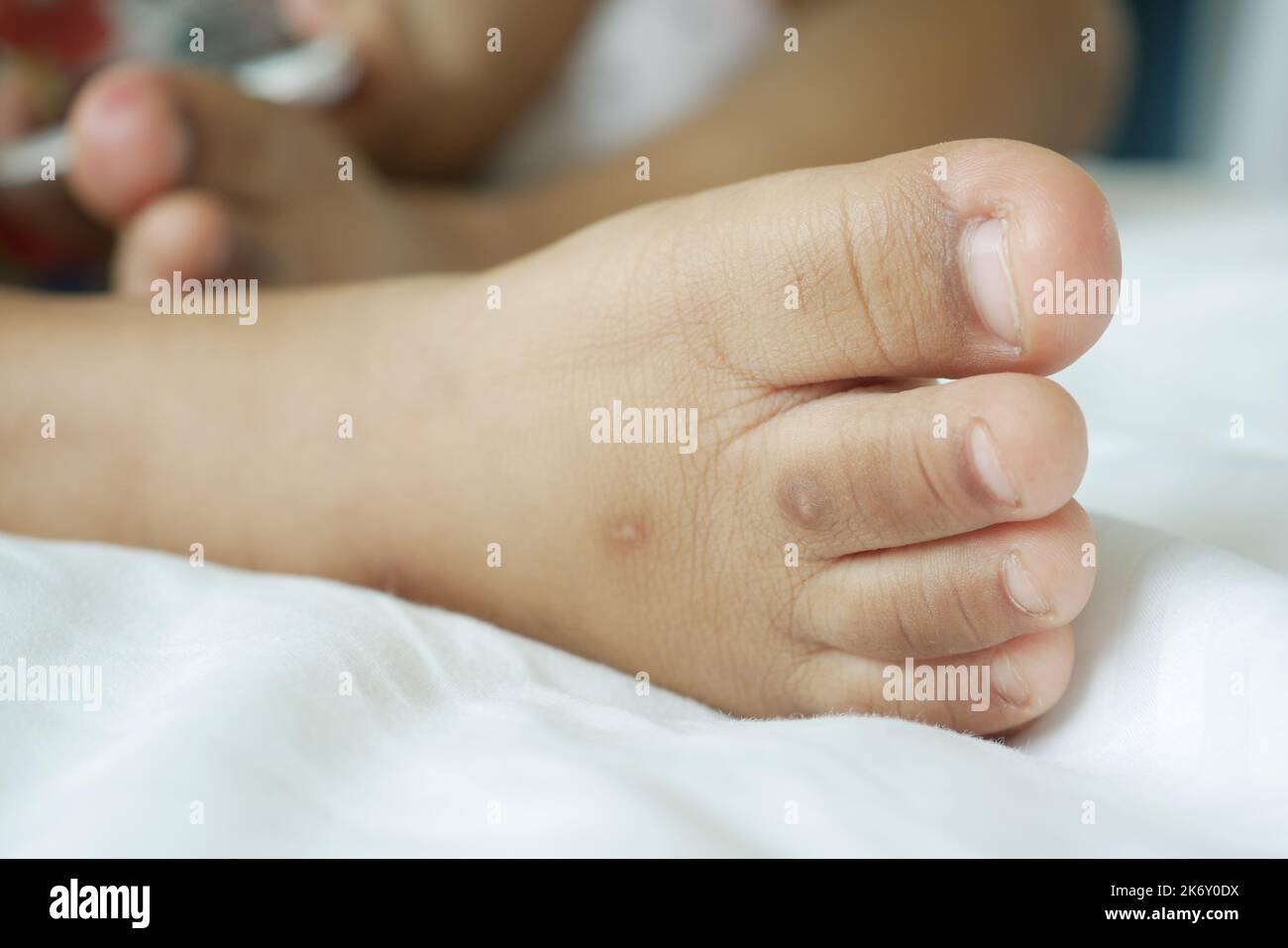 close up of 5 years old child dry feet on bed Stock Photo - Alamy