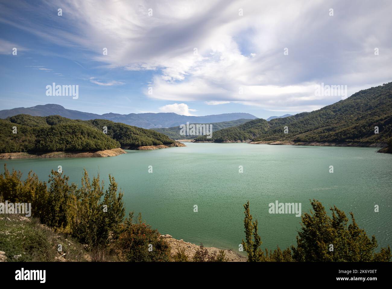 The water reservoir Lake Bovilla and the dam surrounded by mountains ...