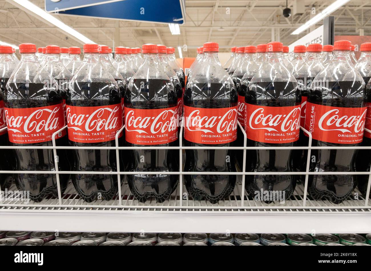 Coca cola in bottles on row display for sale in the supermarket shelves ...
