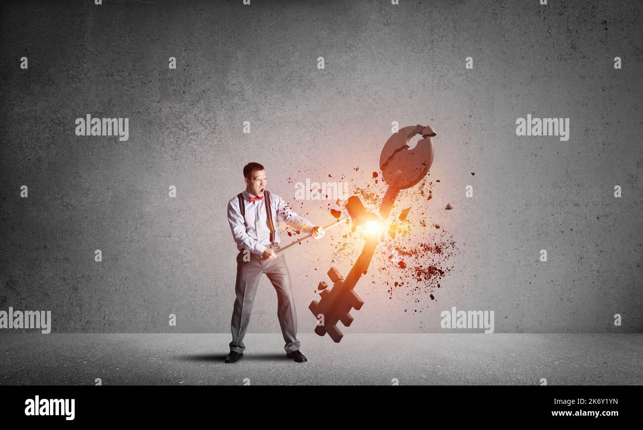 Breaking through access concept with man in room crashing concrete key ...