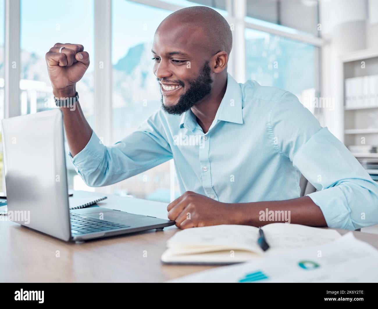 So excited to begin this project. a young businessman cheering while ...