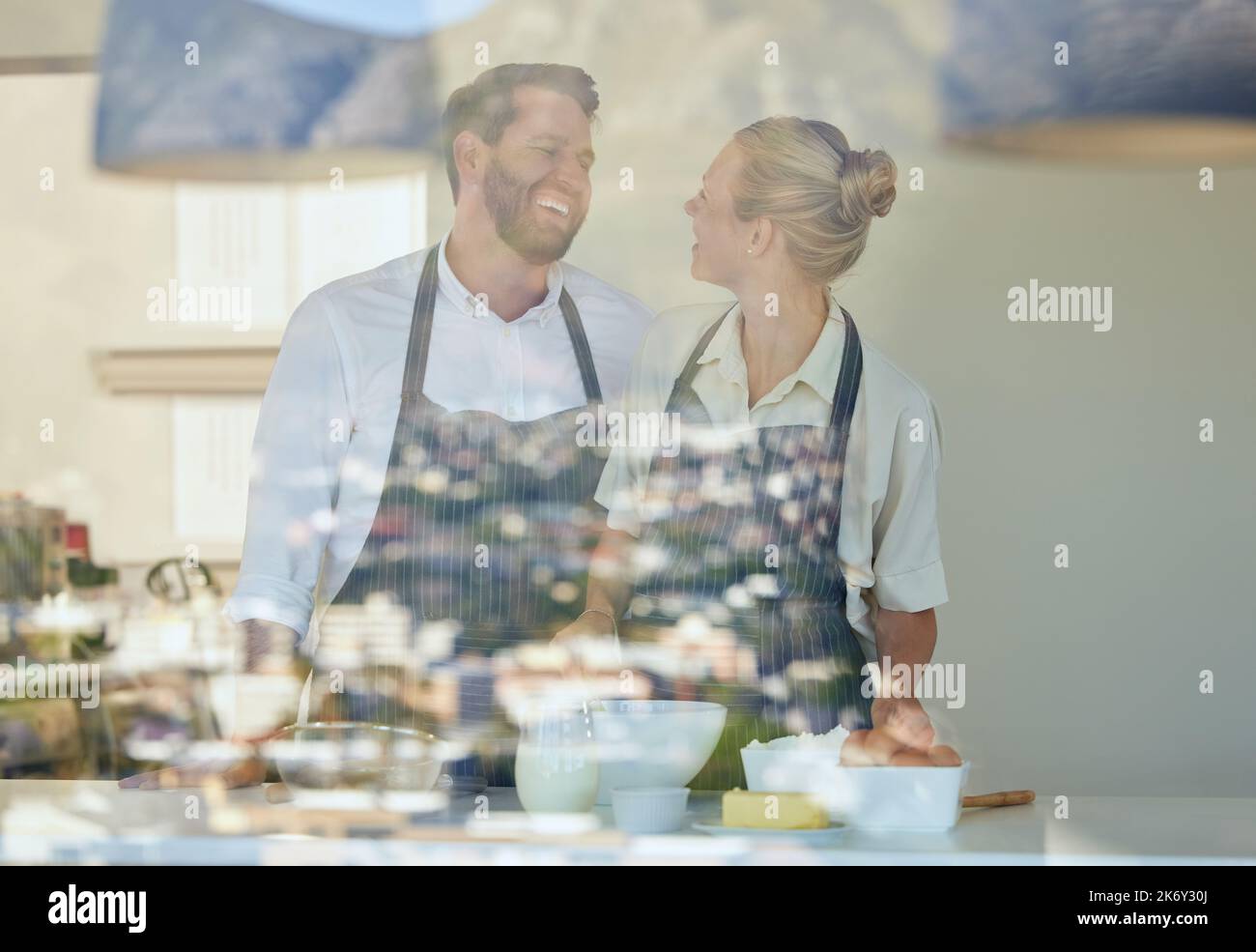 Everything is fun when we do it together. a young couple cooking ...