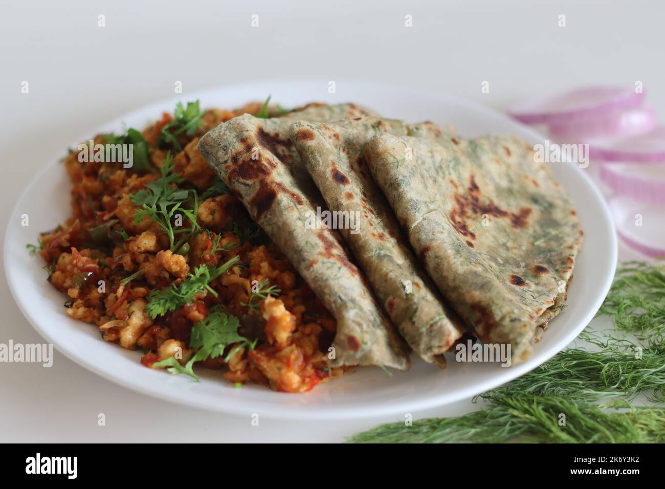 Dil Paratha served with scrambles cottage cheese and garnished with ...