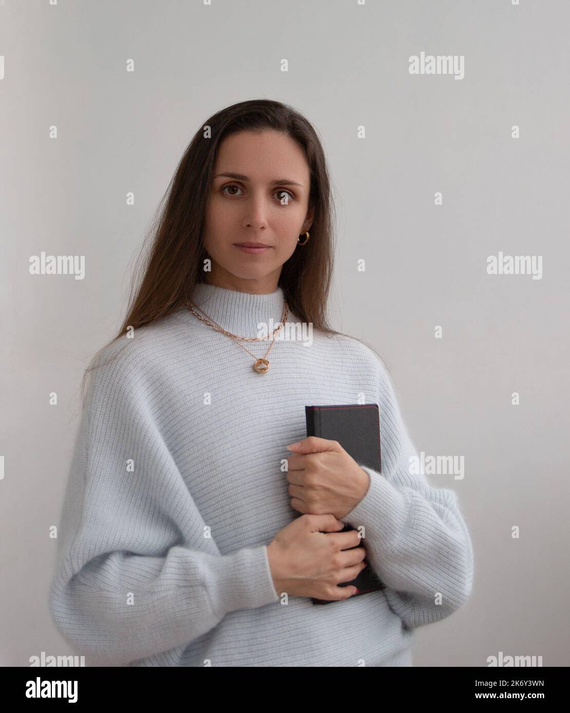 Low angle of young pretty bussines woman standing with arms crossed ...