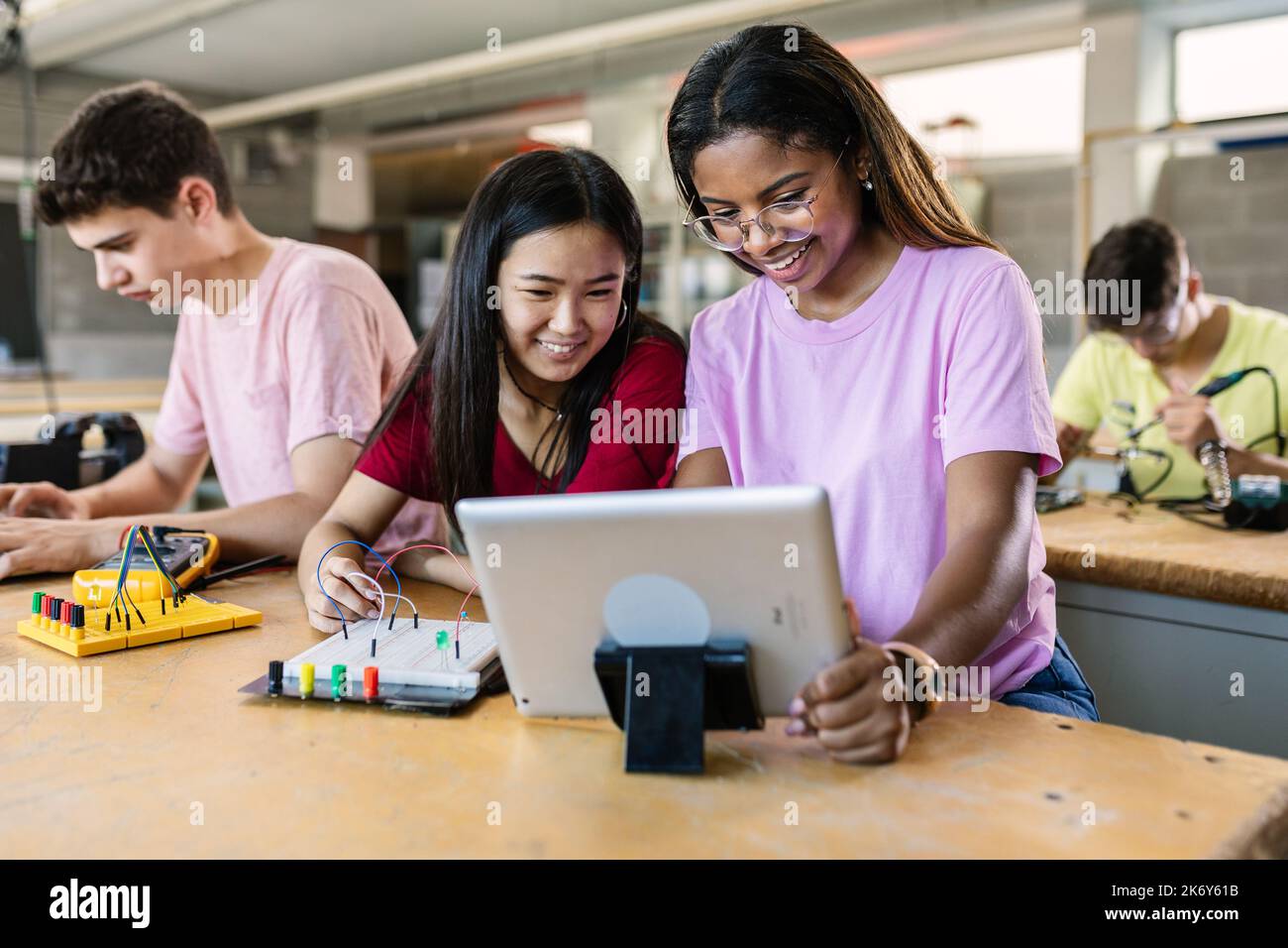 Group of diverse teenage students learning together at technology class ...