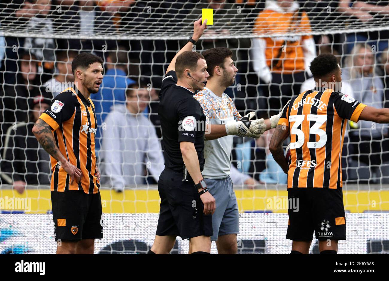 Hull City goalkeeper Nathan Baxter is shown a yellow card by referee ...