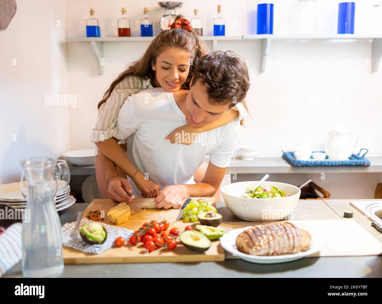 Young couple having fun in the kitchen in the morning, while preparing ...