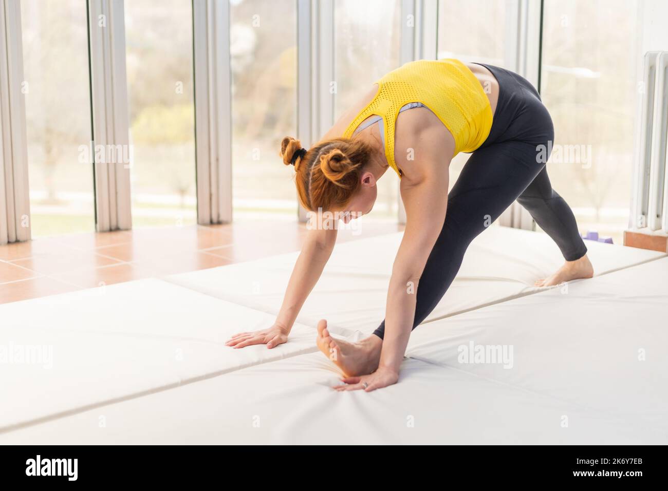 Woman stretching in gym exercise hi-res stock photography and images ...