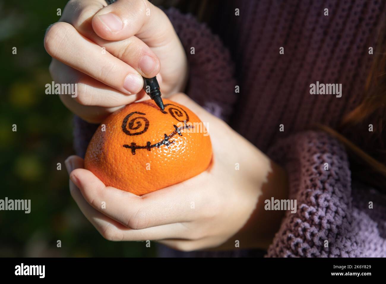 Cropped shot of child preparing for holiday Halloween, hands of child ...