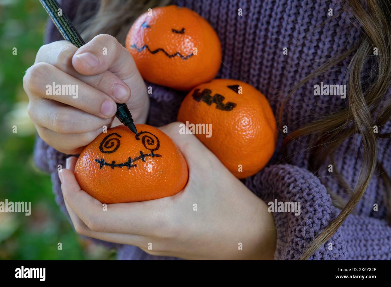Cropped shot of kid preparing for holiday Halloween, hands of child ...