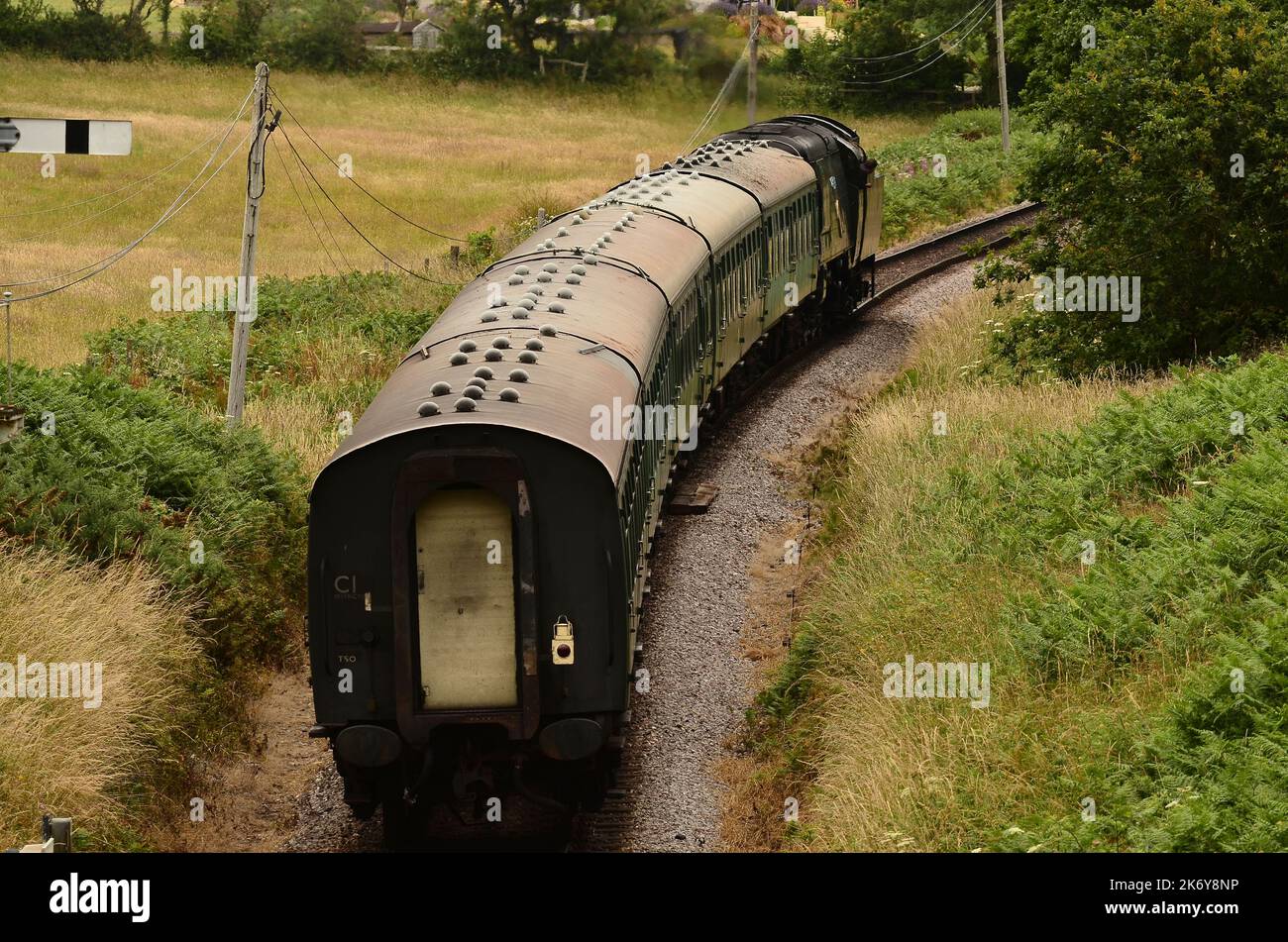 Steam engine and coaches leaving Harman's Cross station on the Swanage ...