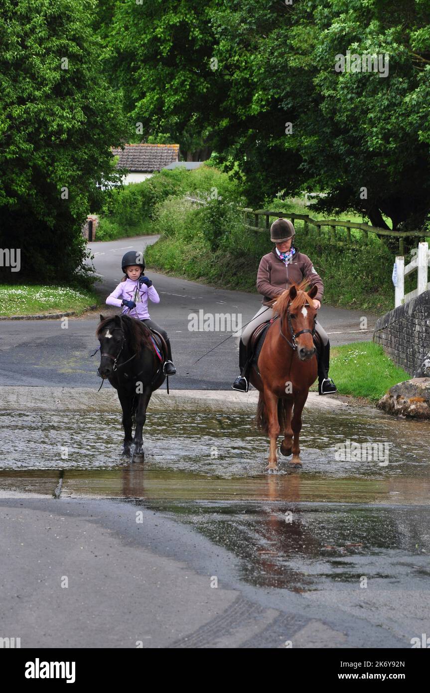 Portrait of pony riders crossing the ford across the river Tarrant at ...