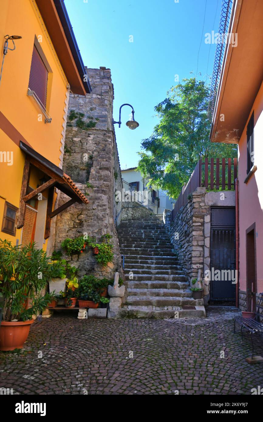 A narrow street between the old stone houses of Frosolone, a medieval village in the Molise ...