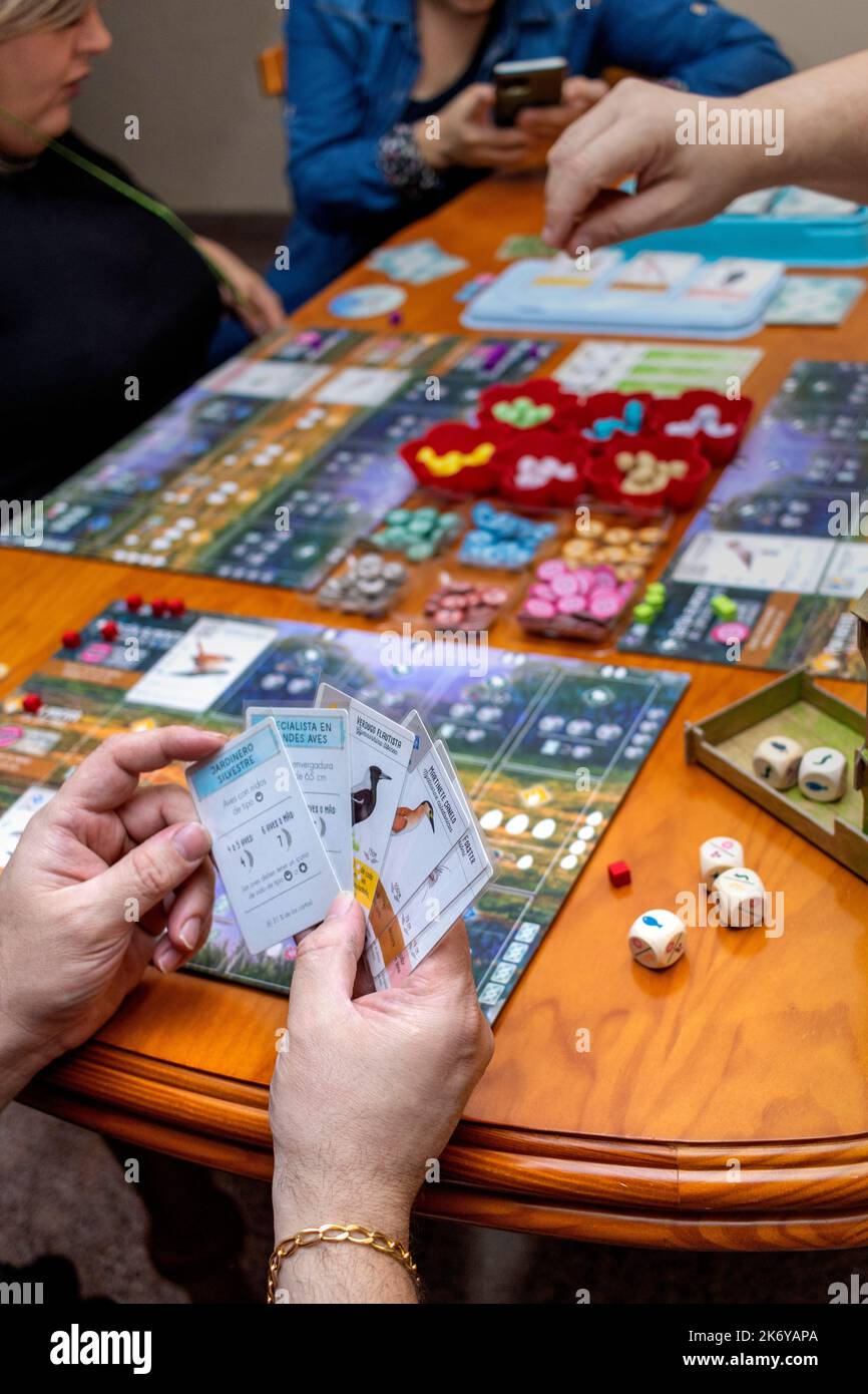 Cheerful friends playing cards hi-res stock photography and images - Alamy