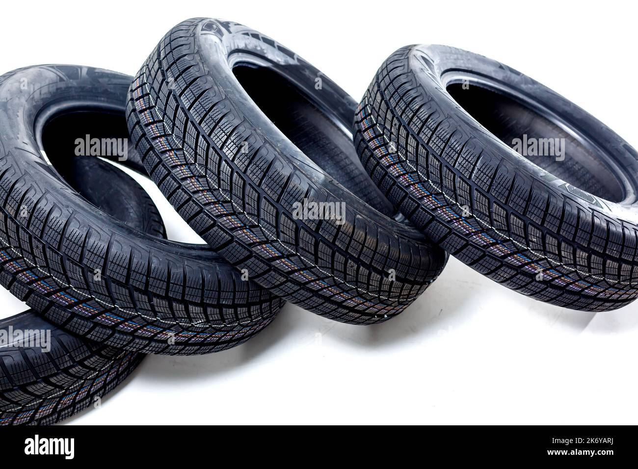 four black tires isolated on white background Stock Photo - Alamy