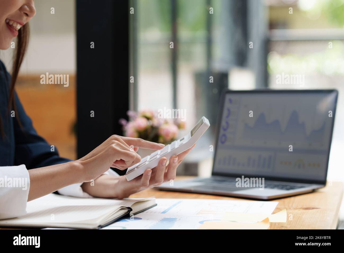 Asian Business woman writing saving account balance with working at ...
