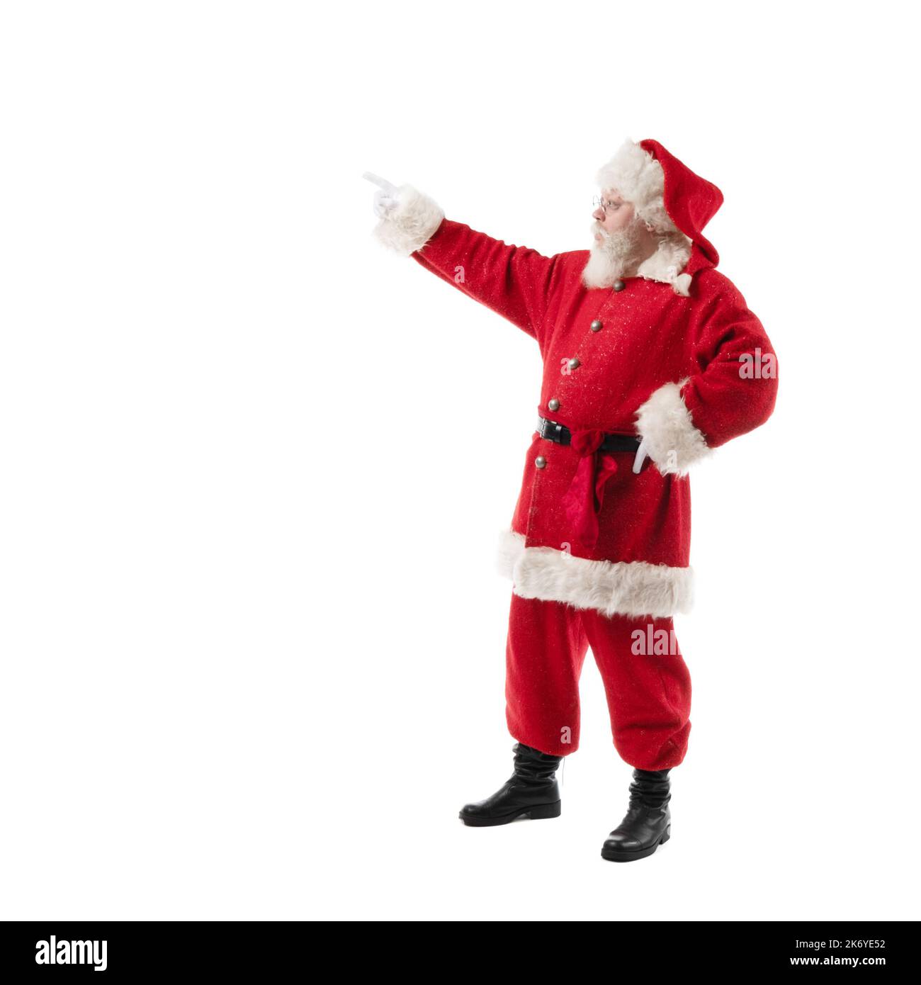 Full length portrait of Santa Claus pointing with finger studio ...