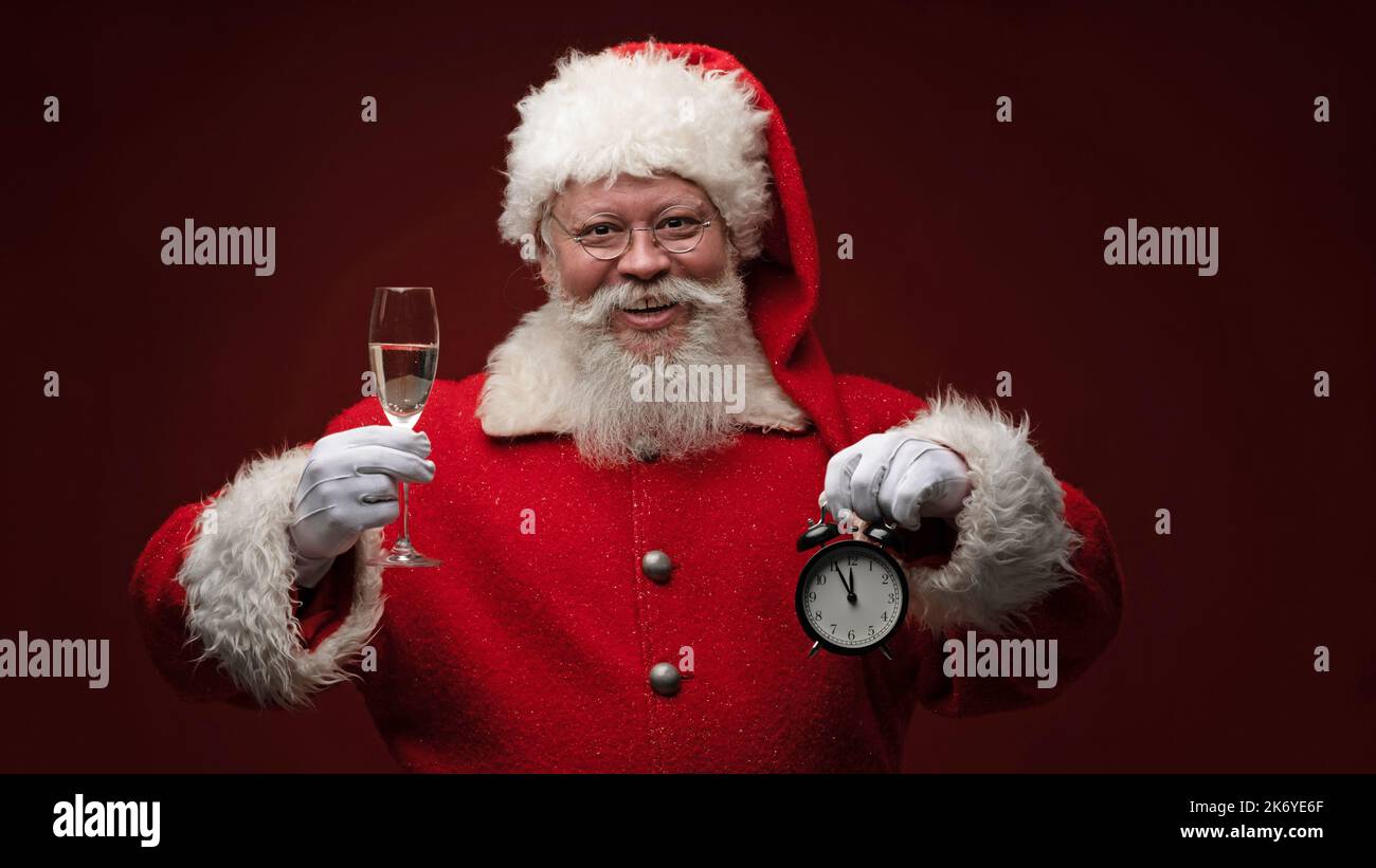 Santa claus with alarm clock almost midnight and champagne Stock Photo ...