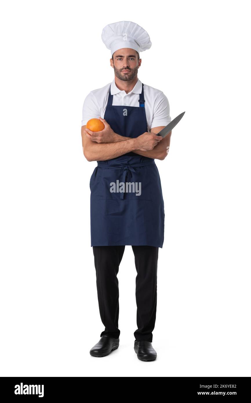 Portrait of a handsome male chef cook holding knife and orange isolated ...