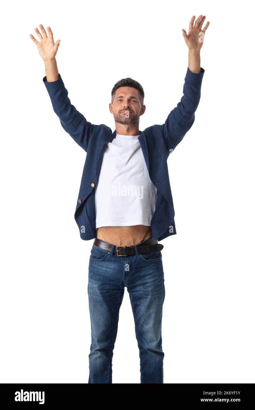 Confident mid adult businessman wearing blazer and jeans with arms ...