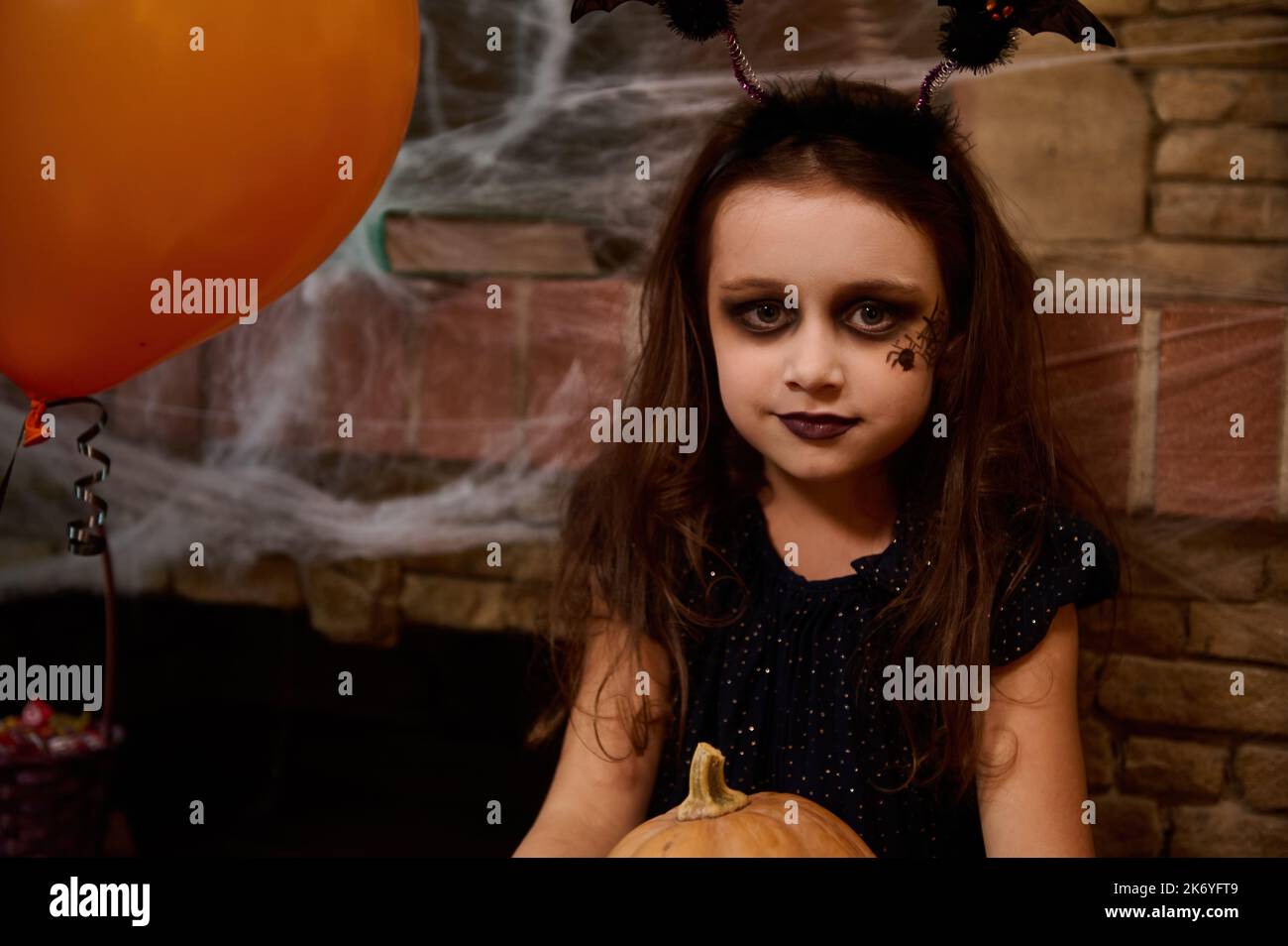 Little girl, looking like a sorceress in witch carnival costume ...