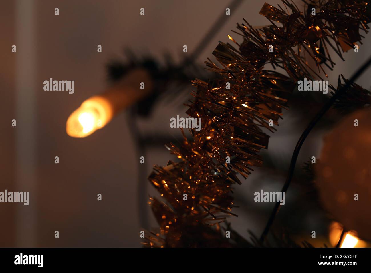 Closeup of Christmas tree branch with golden tinsel and some fake ...