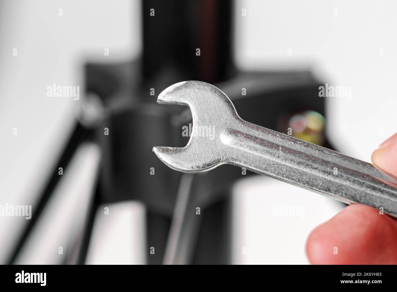 Metal wrench in the hand of a repairman in a workshop close-up Stock ...