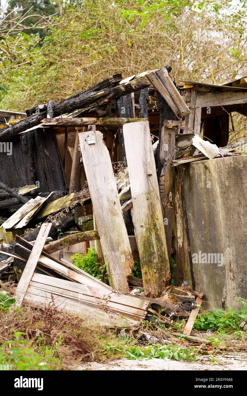 Burnt by fire charred residential rural house. Ruined building. Arson ...