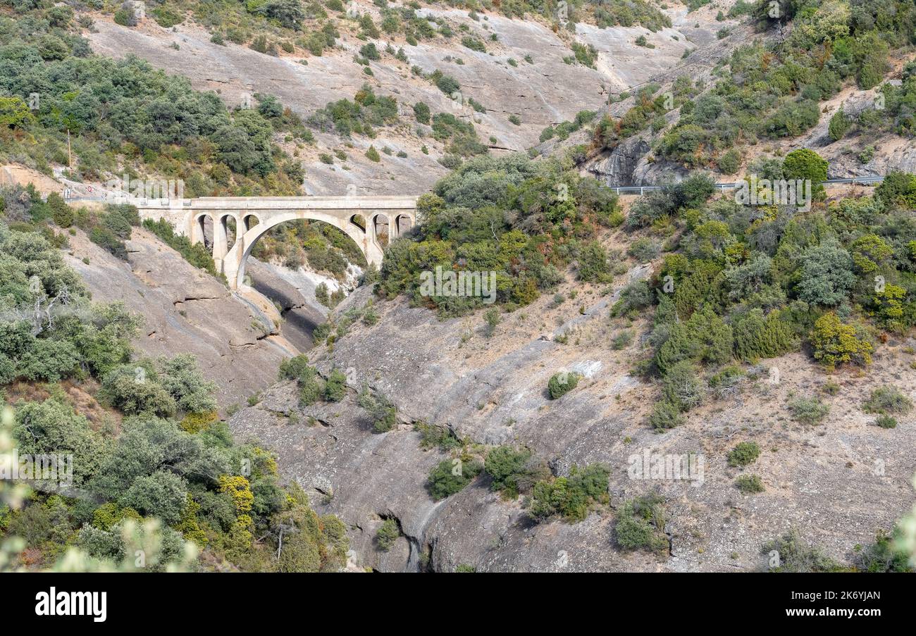 arch span bridge crossing a gorge and river beneath, Pyrenees mountains ...