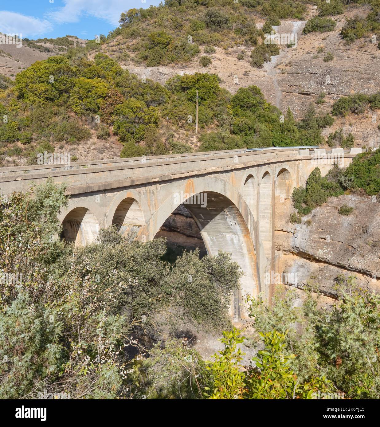 arch span bridge crossing a gorge and river beneath, Pyrenees mountains ...