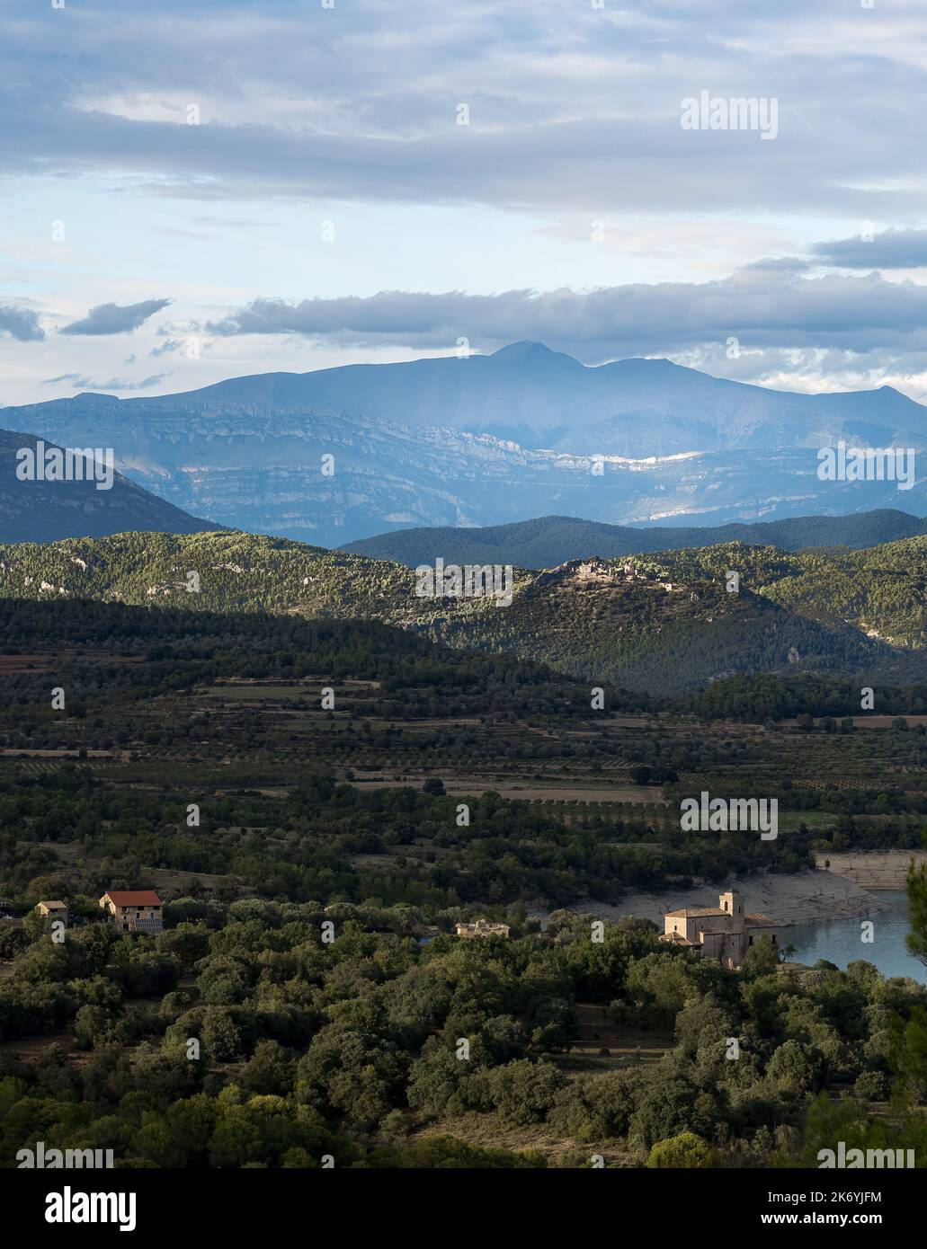 view over a village nestled on the banks of the Embalse de Mediano ...
