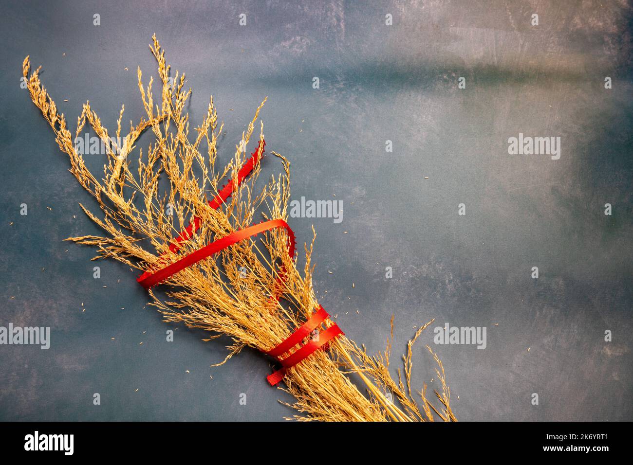 Grass stalks wrapped in red ribbon flat lay Stock Photo - Alamy