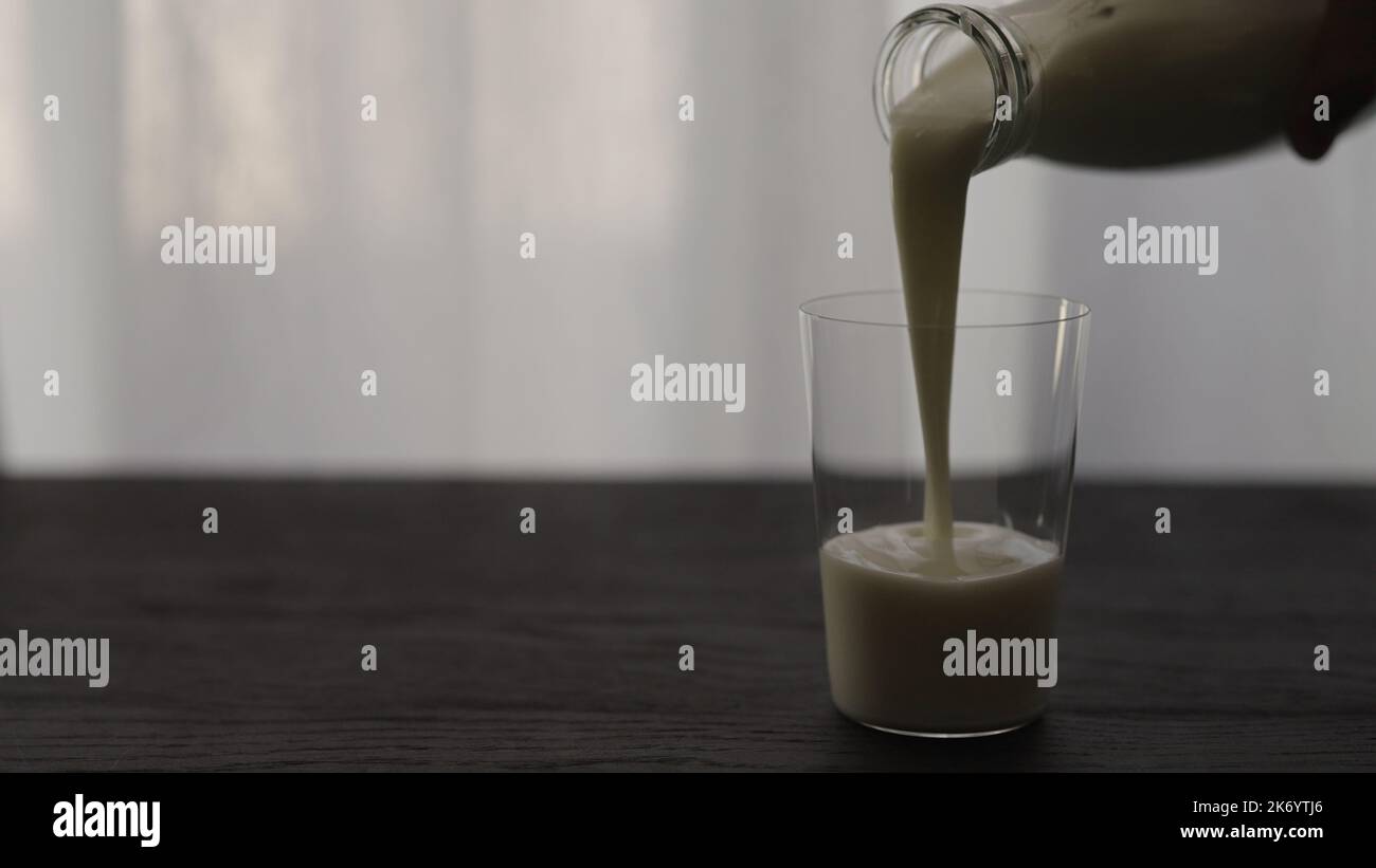 yogurt pour in tumbler glass with copy space, wide photo Stock Photo ...